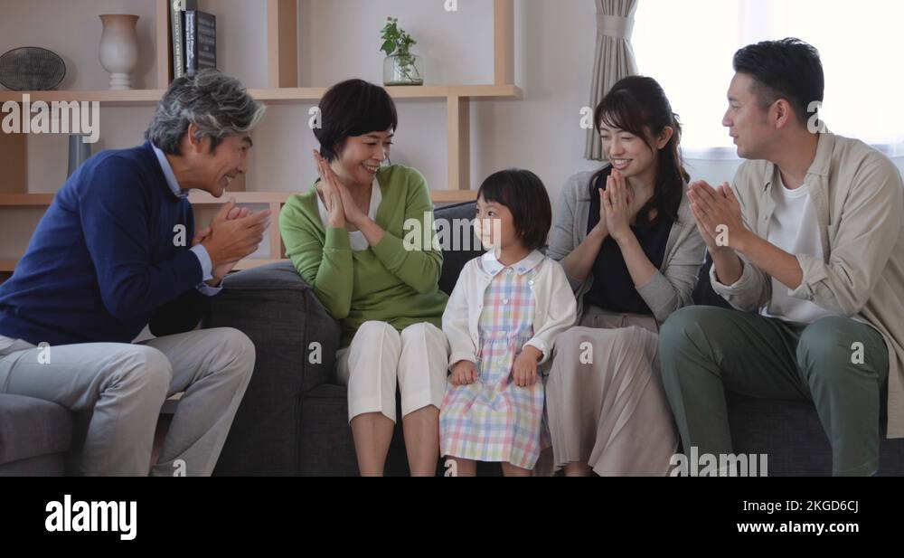 Japanese three-generation family celebrating birthday in the living ...