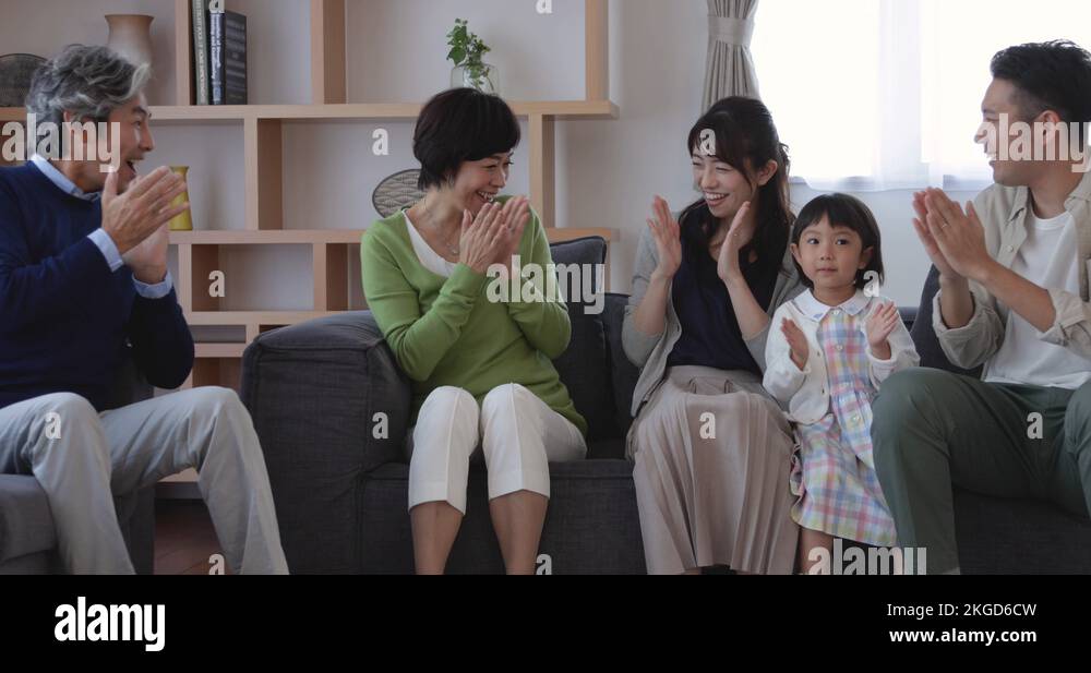 Japanese three-generation family celebrating birthday in the living ...