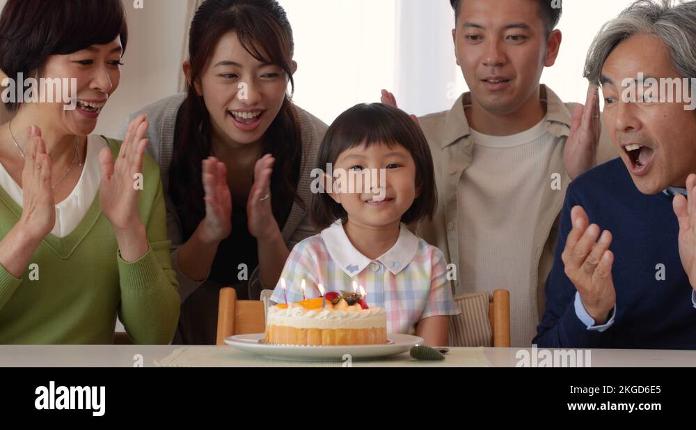 Japanese three-generation family celebrating birthday in the living ...
