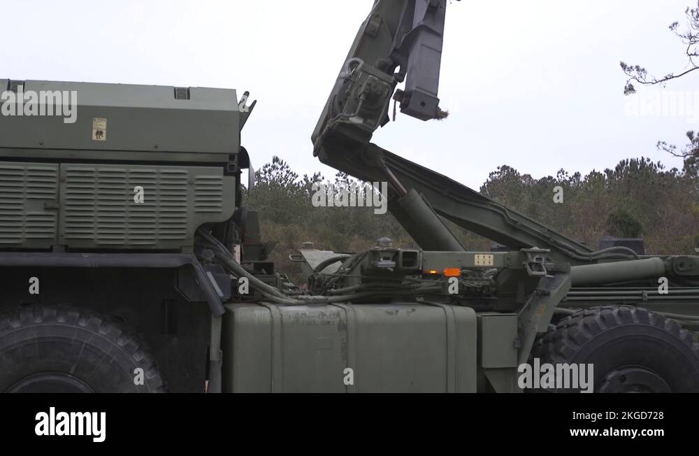 Hydraulic arm being lowered into position on military mobility tactical ...