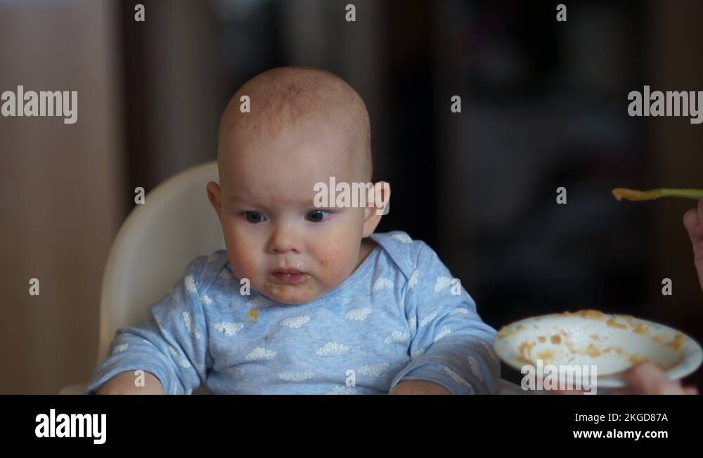 Emotions baby during the first feeding. The child laughs, tries to spit ...
