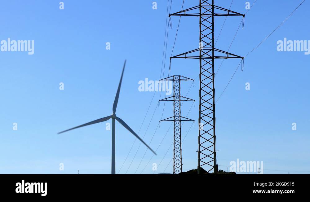 Wind Turbines With Rotating Blades Next to Electrical Towers and Power ...