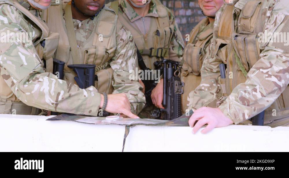 Front view of mixed-race military soldiers with gun planning during ...
