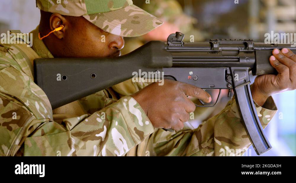 Side view of black military soldiers shooting rifle in target practice ...