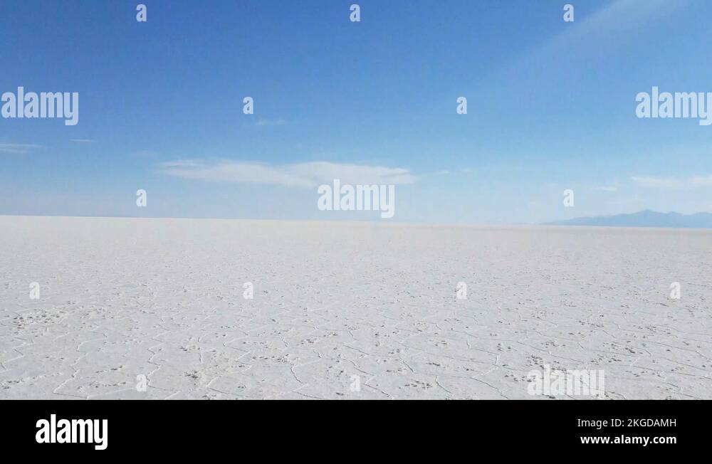 Driving through a panoramic view of The Uyuni Salar in Bolivia. White ...