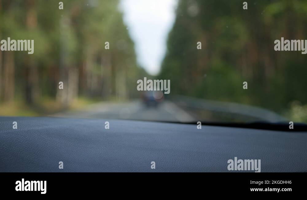 Blurred view through the front window of the car. The car goes on a ...