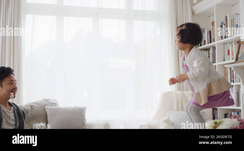 Girl jumping into father arms Japanese family bonding child learning ...
