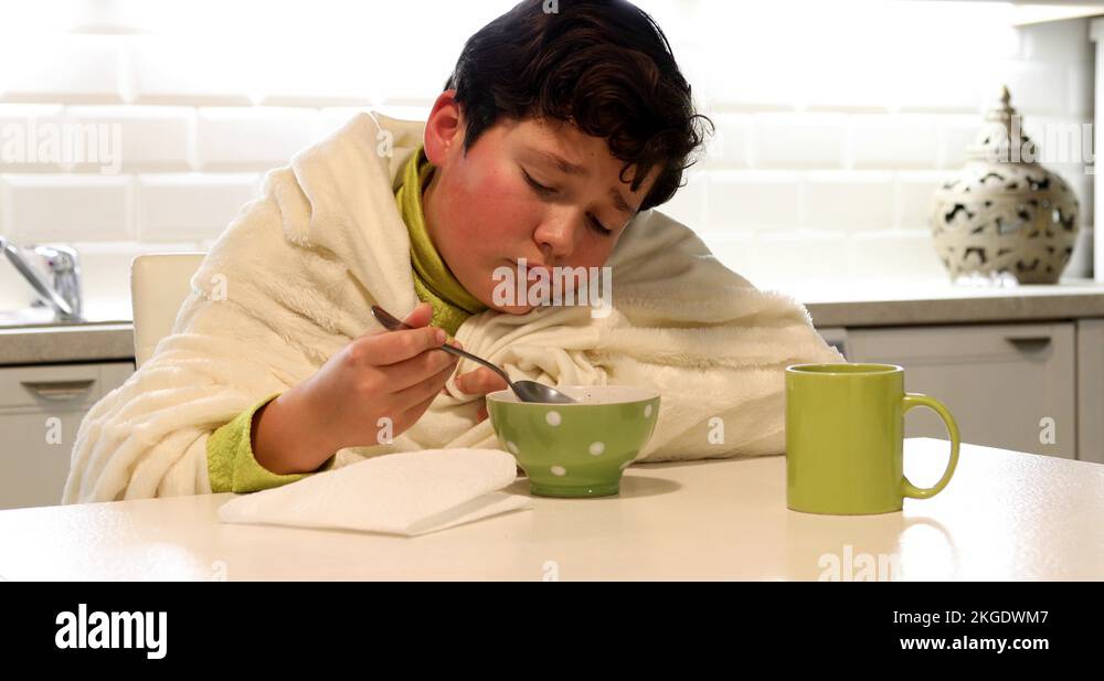 Sick child eating hot soup 4 Stock Video Footage - Alamy