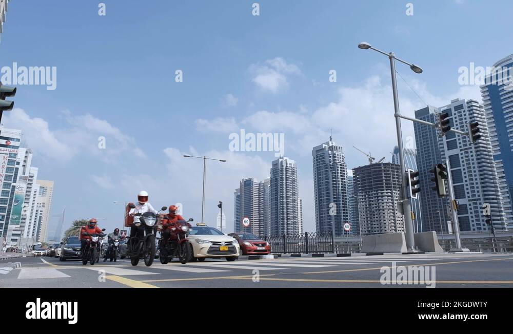 Road traffic in Dubai. Many cars and motorcycles at the intersection of ...