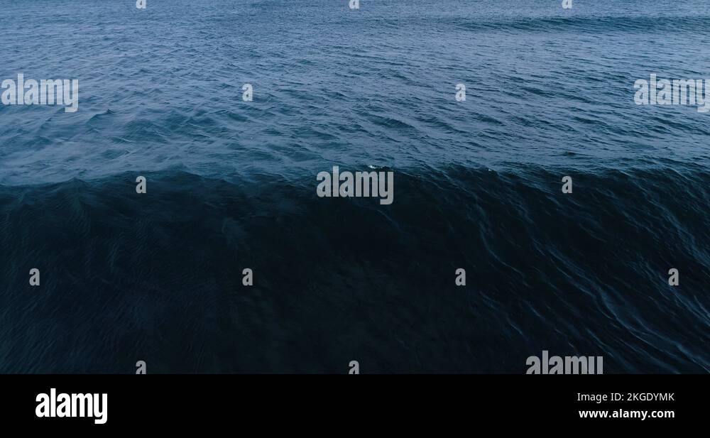 Big wave moves on dron camera flying backwards over the ocean, slow ...