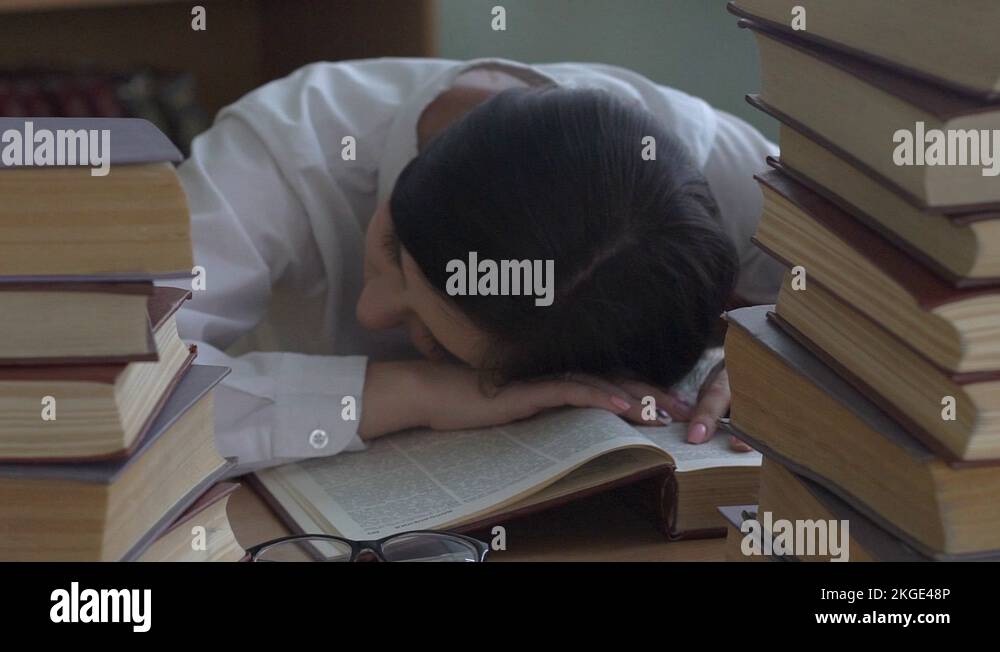 Student Girl Napping And Sleeping On Desk With Books In Library Stock ...