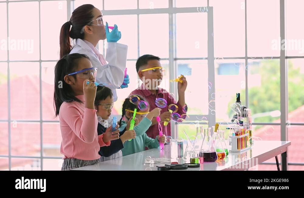 Students and teacher blowing bubbles in lab Stock Video Footage - Alamy