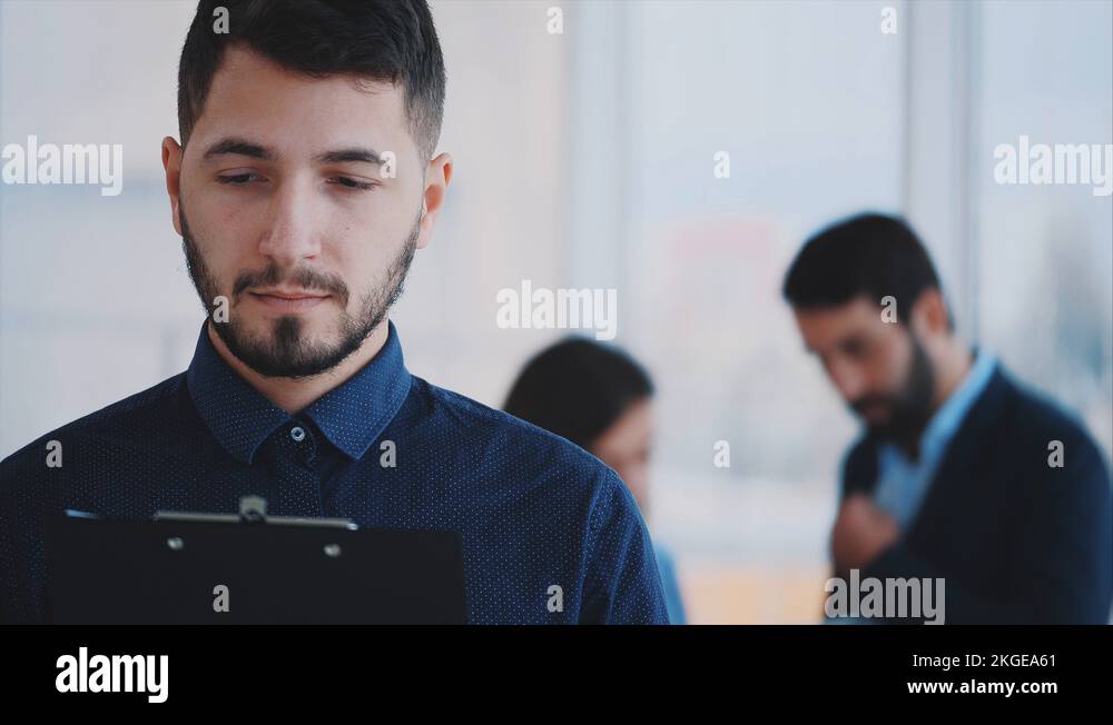 A business partner keeps a folder in his hands while reading a new ...