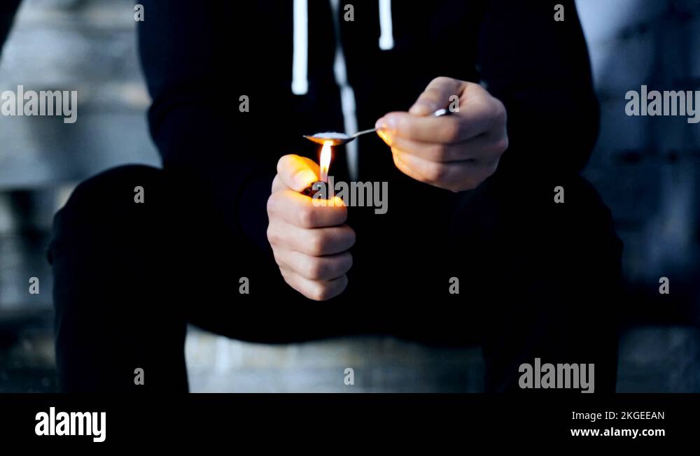 addict making crack cocaine drug dose by fire Stock Video Footage - Alamy