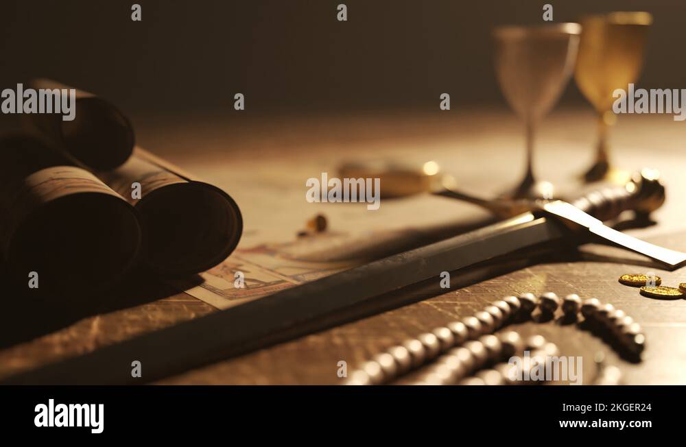 The vintage compass on the ancient map next to the sword, goblets and ...