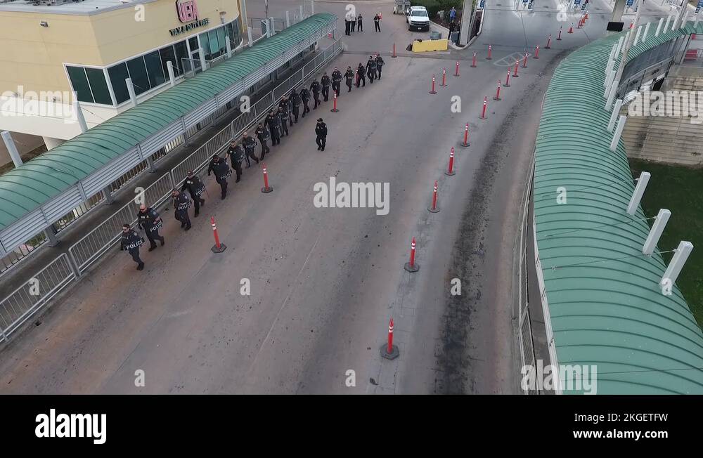 CBP officers walking with riot shields on Gateway to the Americas ...