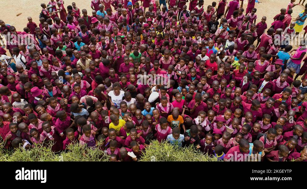 4K close-up aerial static then zoom out view of a rural school with a ...