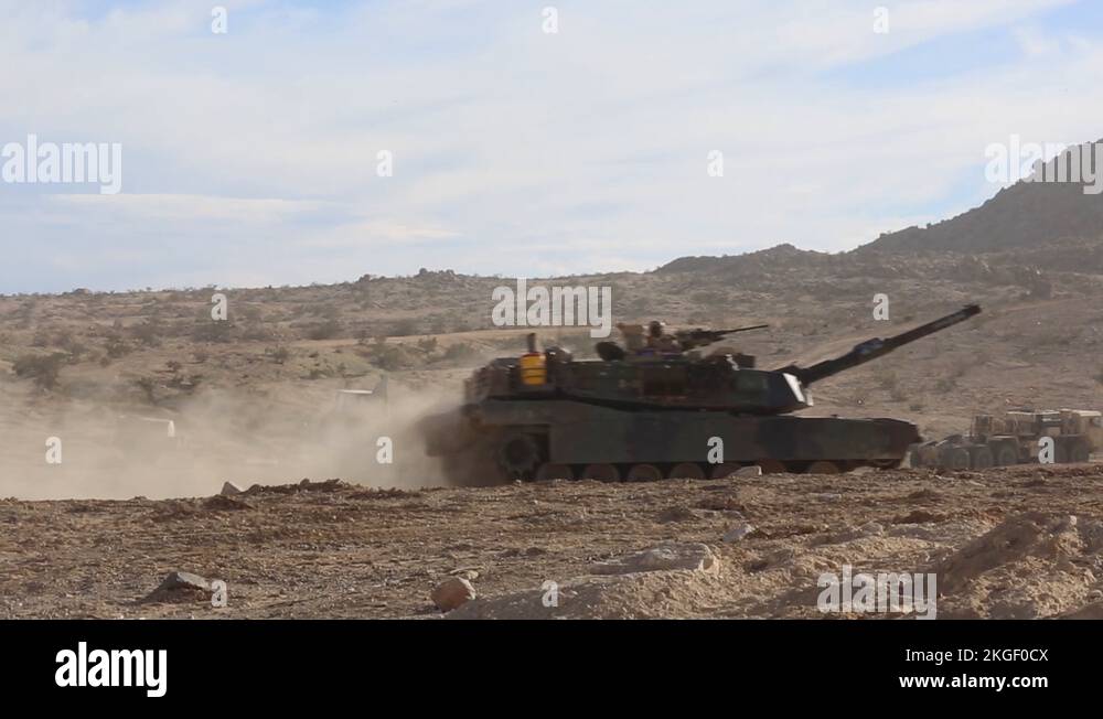M1 Abrams battle tank tracking over sand during mechanized assault ...