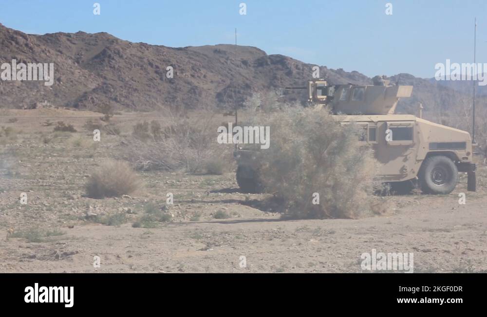 Soldier firing machine gun from turret of Humvee armored vehicle Stock ...