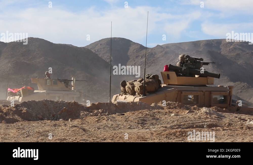 U.S. Marines firing machine guns from turrets of Humvee armored ...