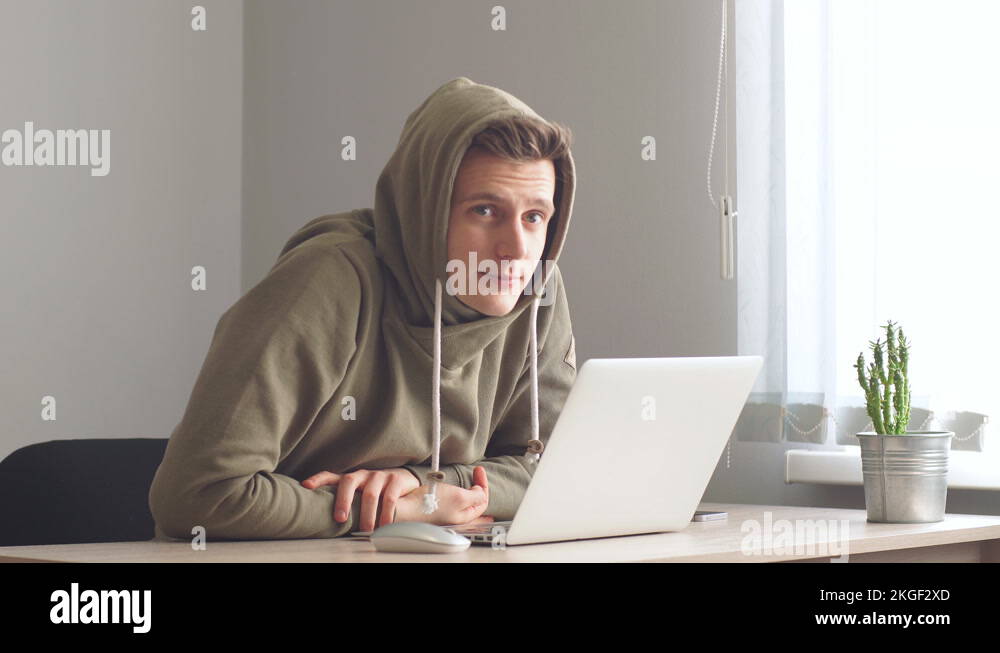 Young hacker concentrated on coding, hacker looking at screen ...