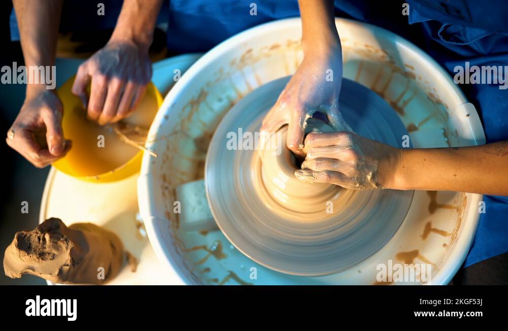 Traditional pottery making, man teacher shows the basics of pottery in ...