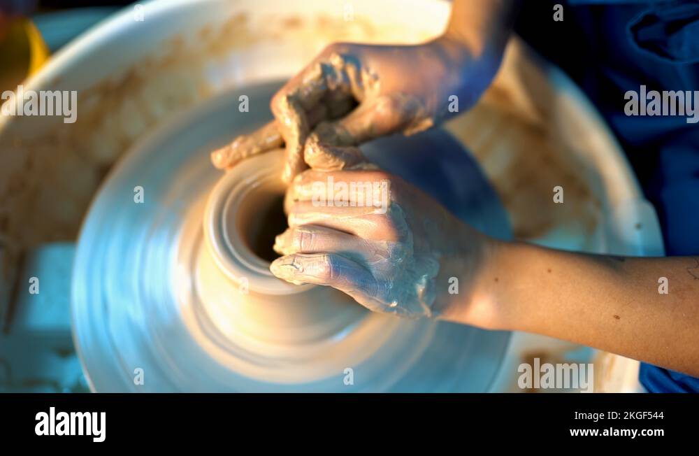 Traditional pottery making, man teacher shows the basics of pottery in ...