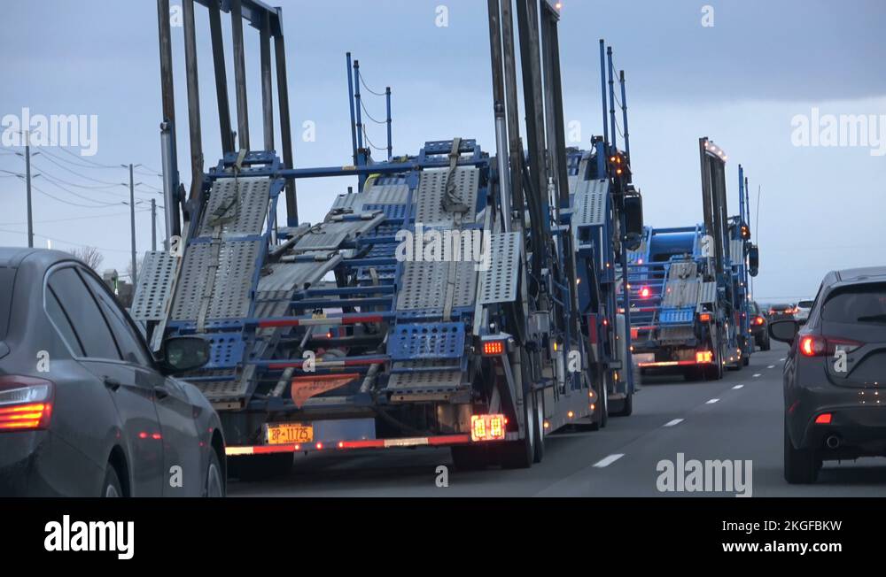 Two tractor units with a car carrier trailer on QEW highway in Ontario ...