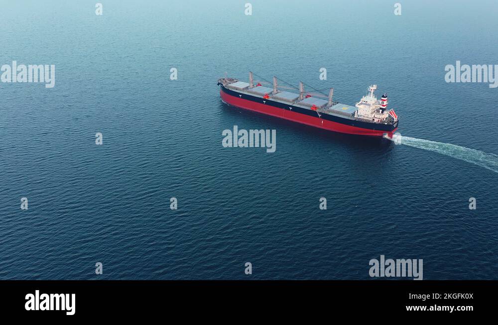 A large high-speed sea vessel a cargo ship at high leaves the city sea ...