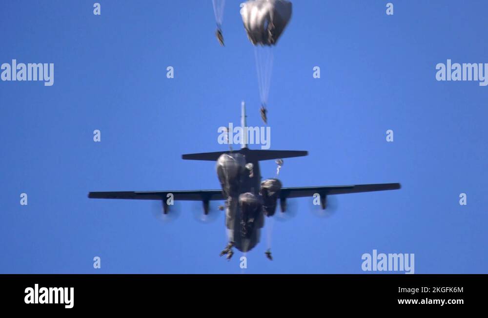 Paratroopers exiting C-130 Hercules during airborne operation Stock ...