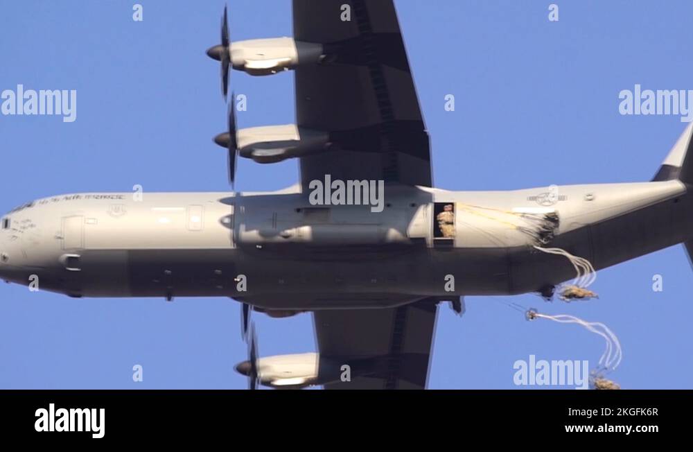 Birds eye view of U.S. Army paratroopers exiting side door of C-130 ...