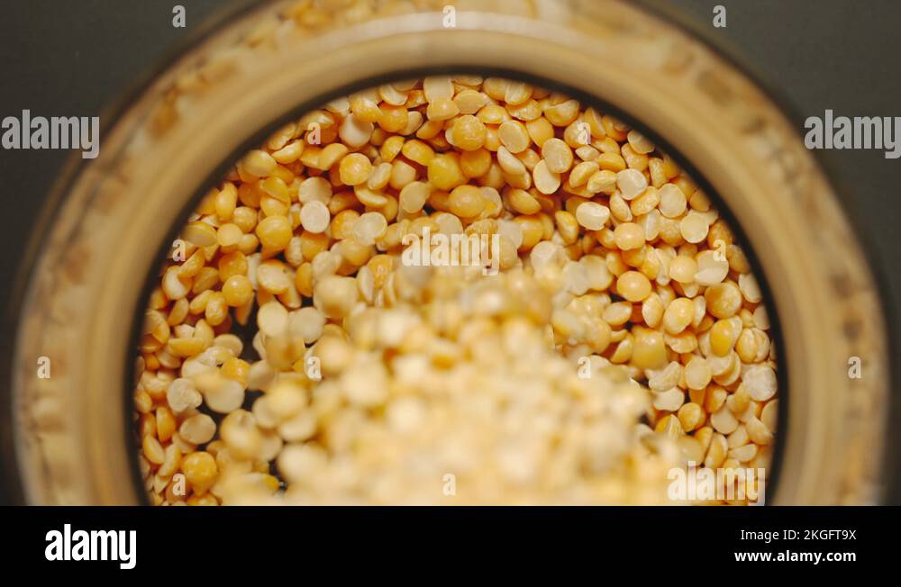 TOP VIEW: Yellow peas pouring into a glass jar - Slow Motion Stock ...