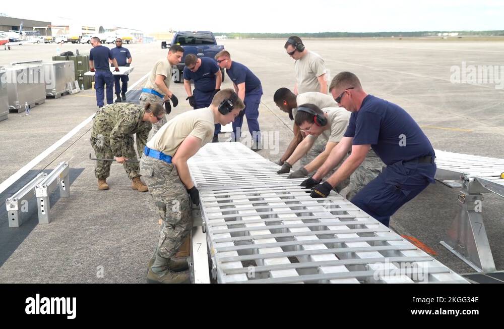 Airmen positioning ramps for offloading cargo from C-17 Globemaster ...