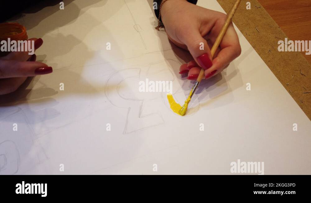 Close up shot of a young female artist in a process of creating an ...