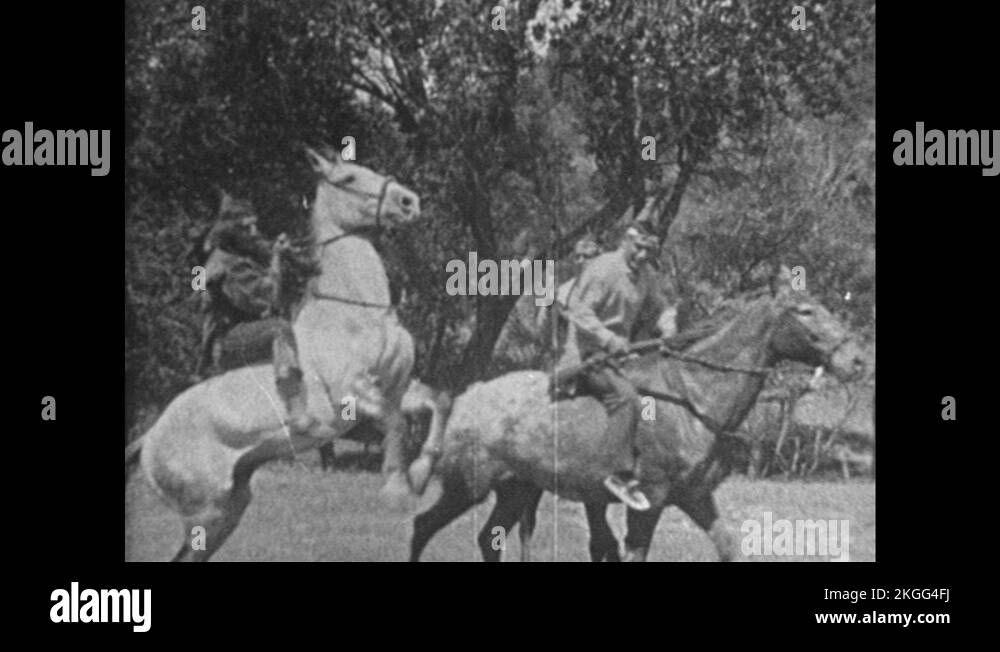 1920s: Indians with rifles ride on horseback. Man and woman talk on ...