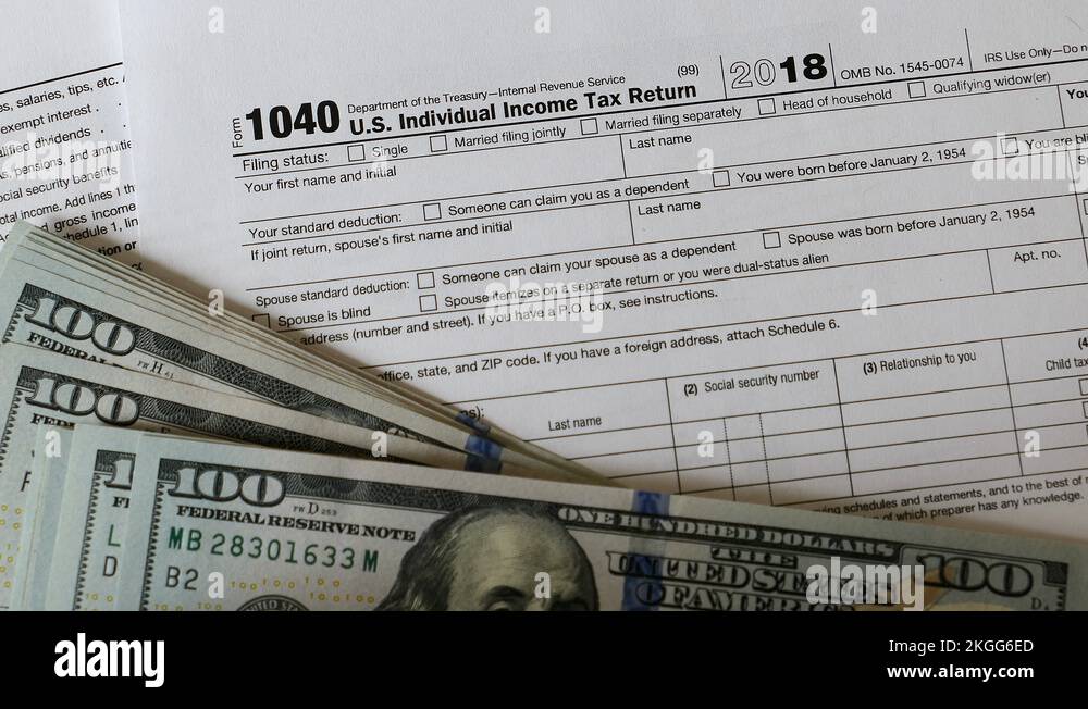 An Elderly Man Signs Irs Us Individual Income Tax Form 1040. Fake ...