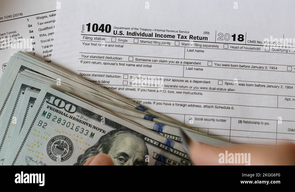 An Elderly Man Signs Irs Us Individual Income Tax Form 1040. Fake ...