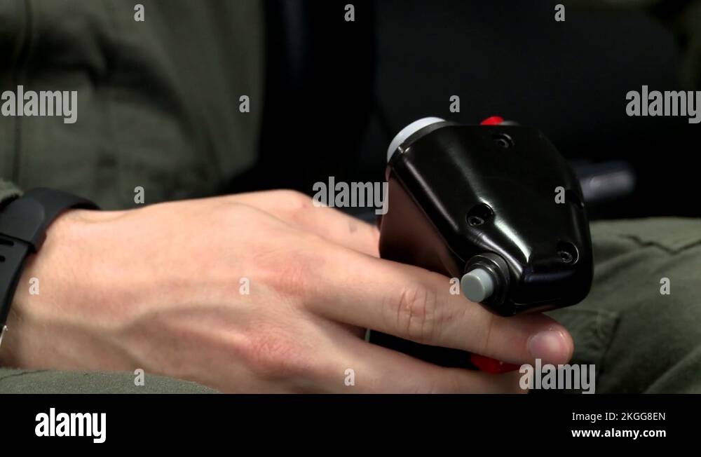 Trainee pilot operating joystick of virtual reality flight simulator ...