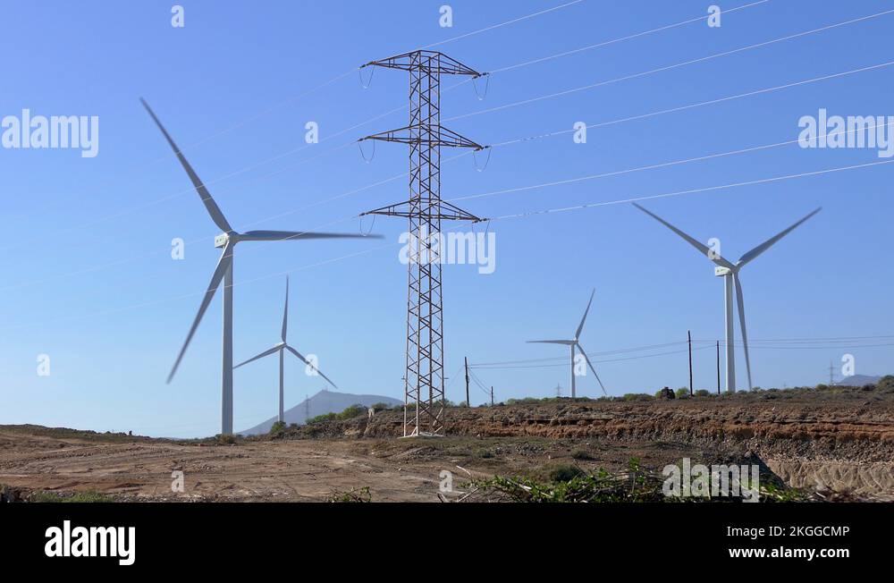 Wind Turbines With Rotating Blades Next to Electrical Towers and Power ...