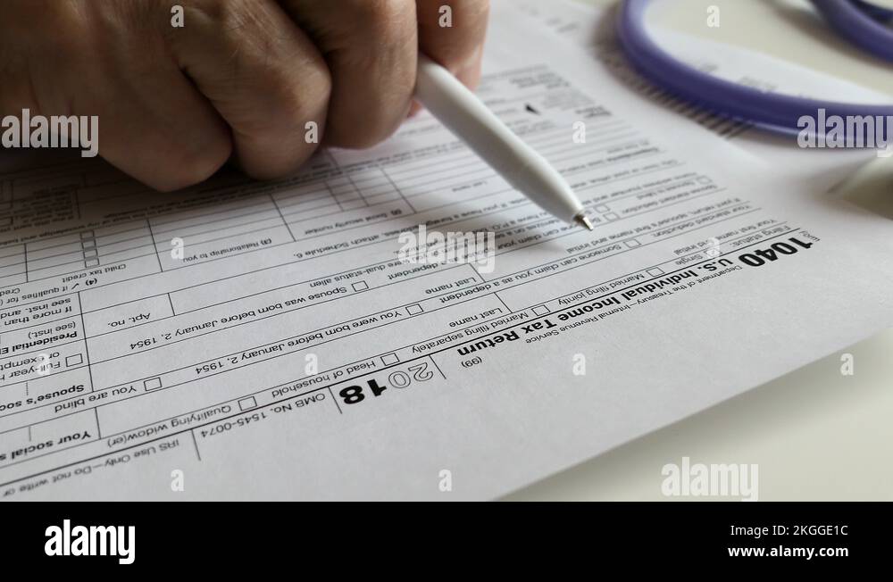 Male Medical Doctor Reads Irs Us Individual Income Tax Form 1040 ...