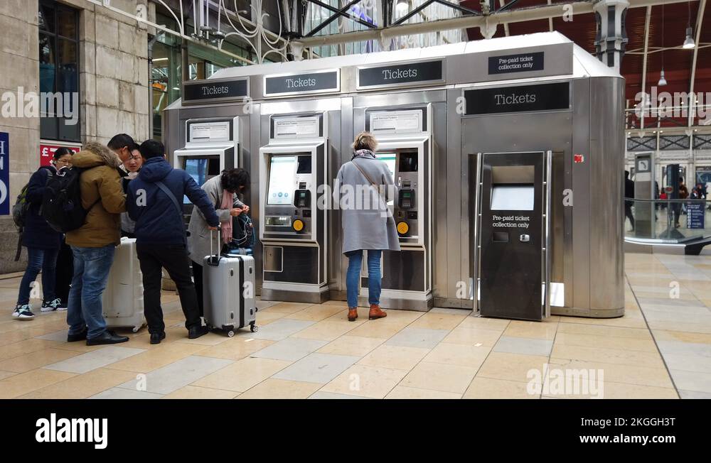 Passengers use self service train ticket machines at Paddington Station ...