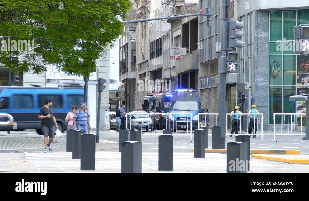 Police van motorcade turning corner in large city of Buenos Aires at ...