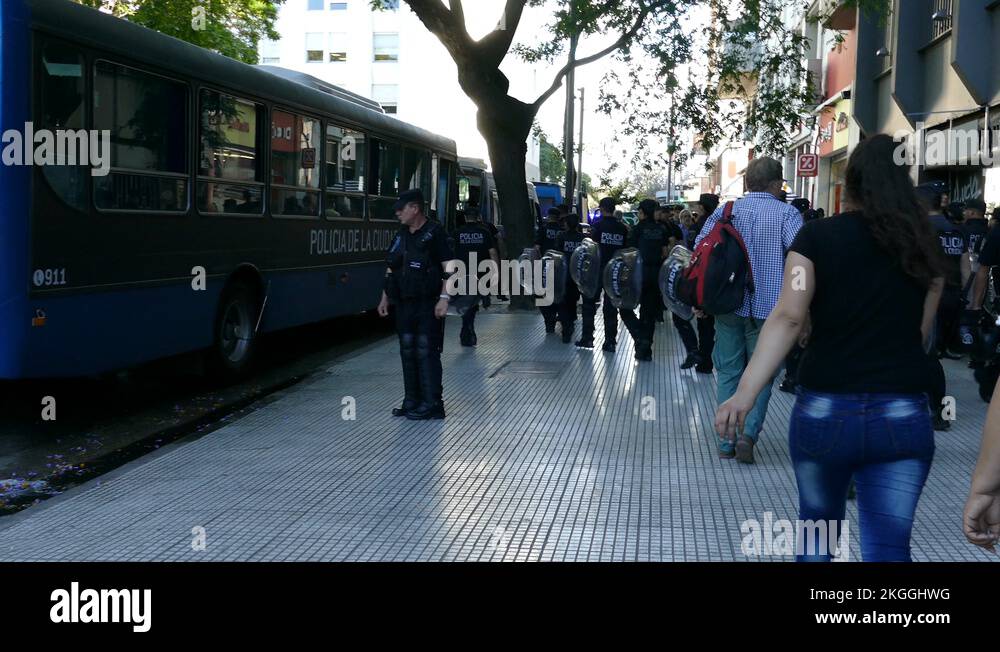 Cameraman walking and following line of riot officers going back to bus ...