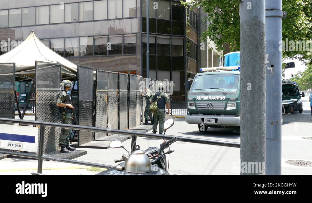 Heavily armed officers guarding entry point of safety perimeter during ...