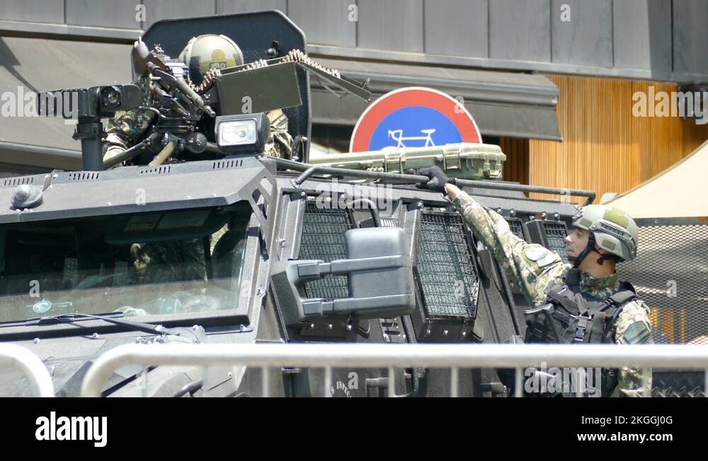 Heavily armed cops standing on cool looking armoured police vehicle at ...
