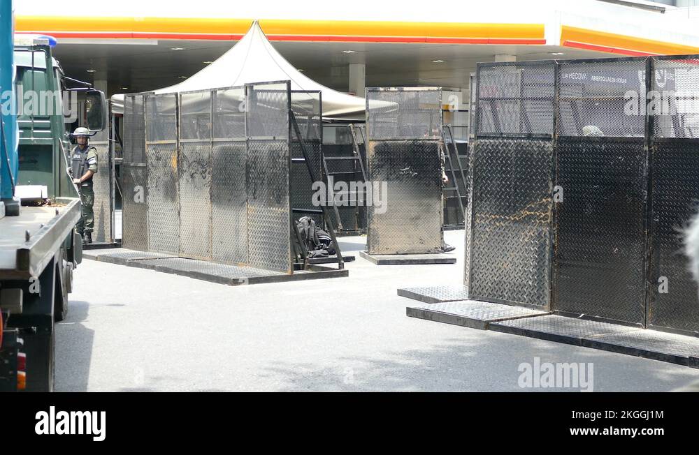 Truck carrying porta potty entering safety zone protected by heavy ...