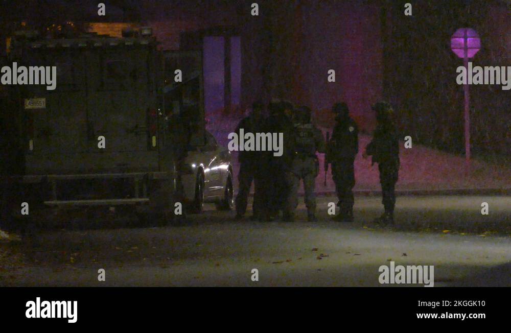 Tactical police team silhouette standing by in street near armored ...