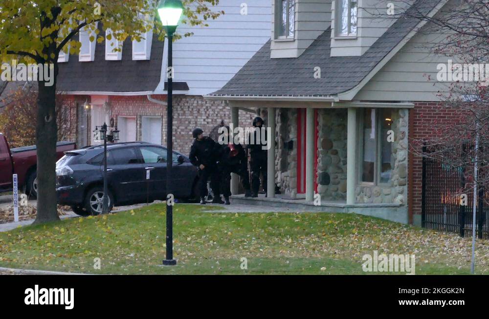 Swat type police officers using PA voice system during tense standoff ...