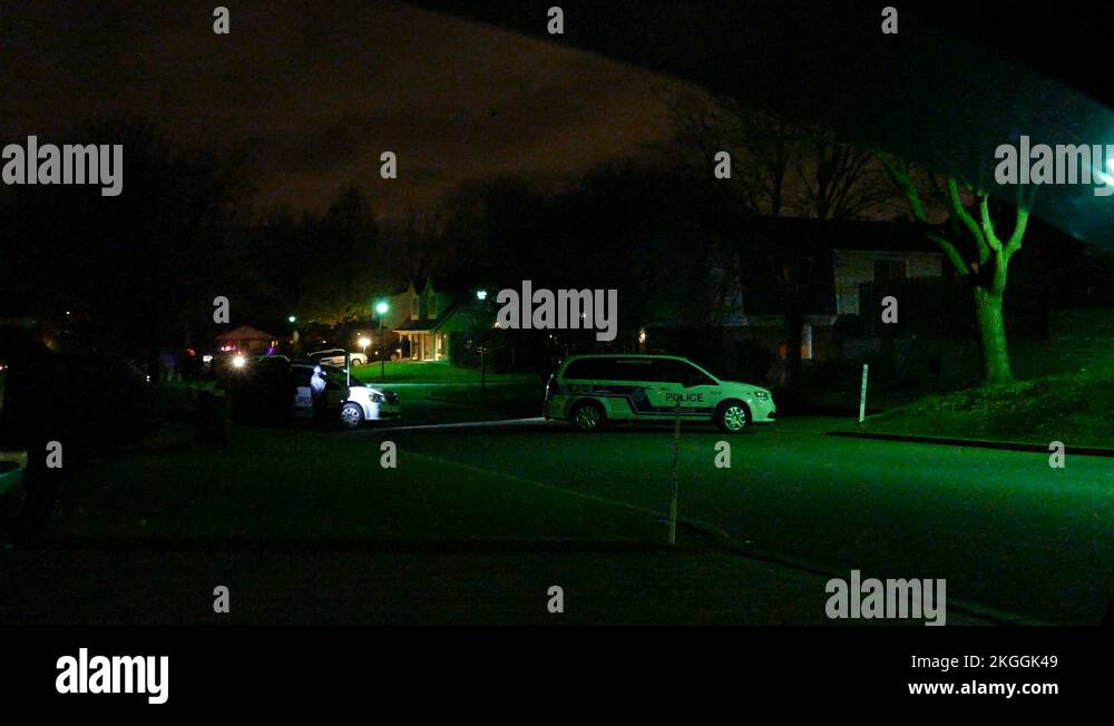 Hidden police officers shine bright flashlight towards suspect's house ...