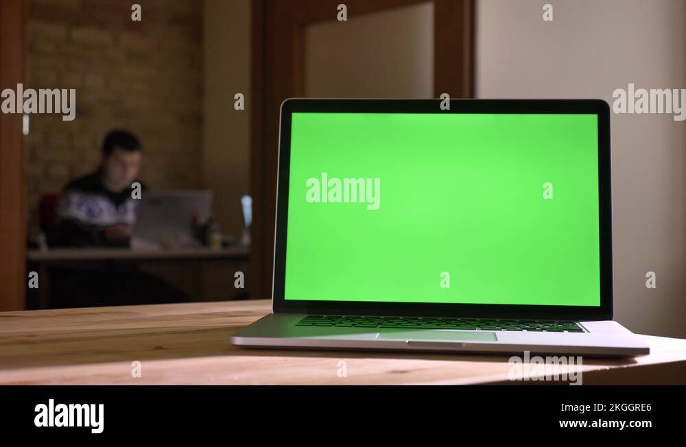 Closeup shoot of green screen of the laptop laying on the desk in ...